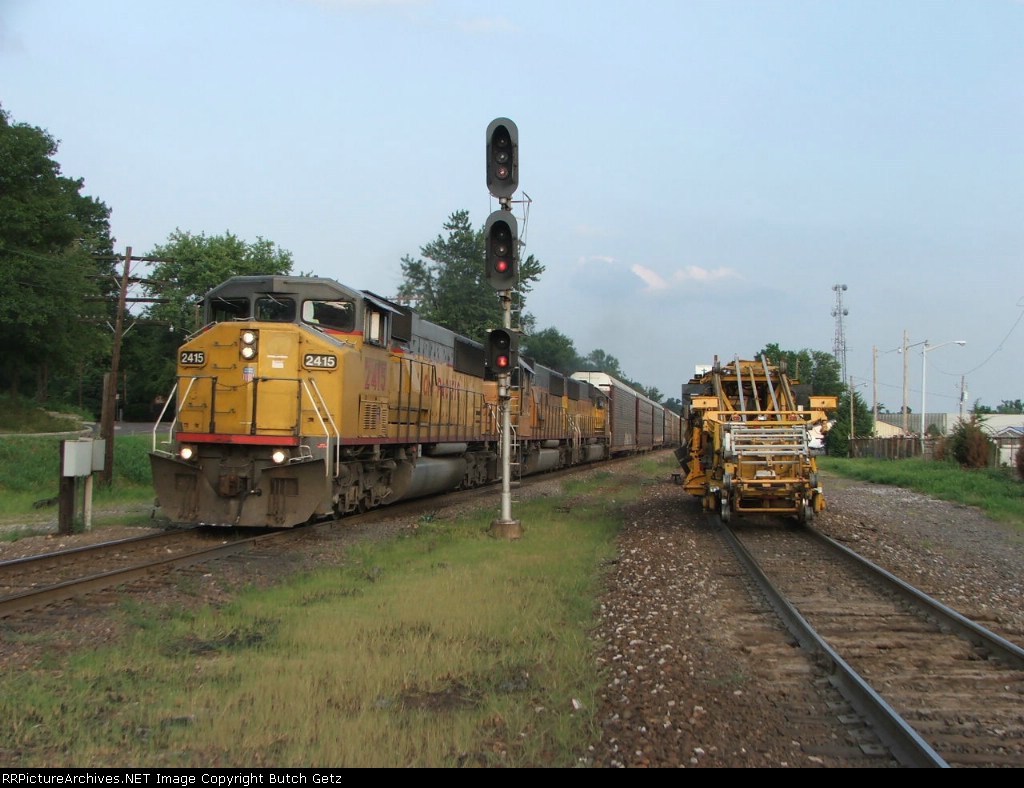 UP 2415 passes MOW equipment headed for a siding at Kirkwood, MO